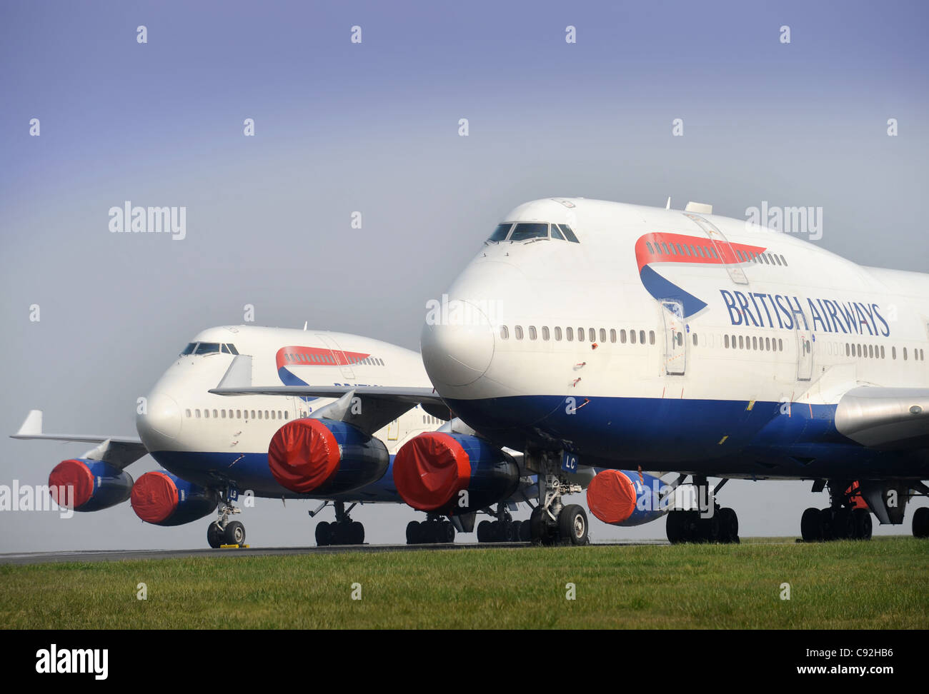 Two British Airways Boeing 747 passenger jets with engine covers parked ...