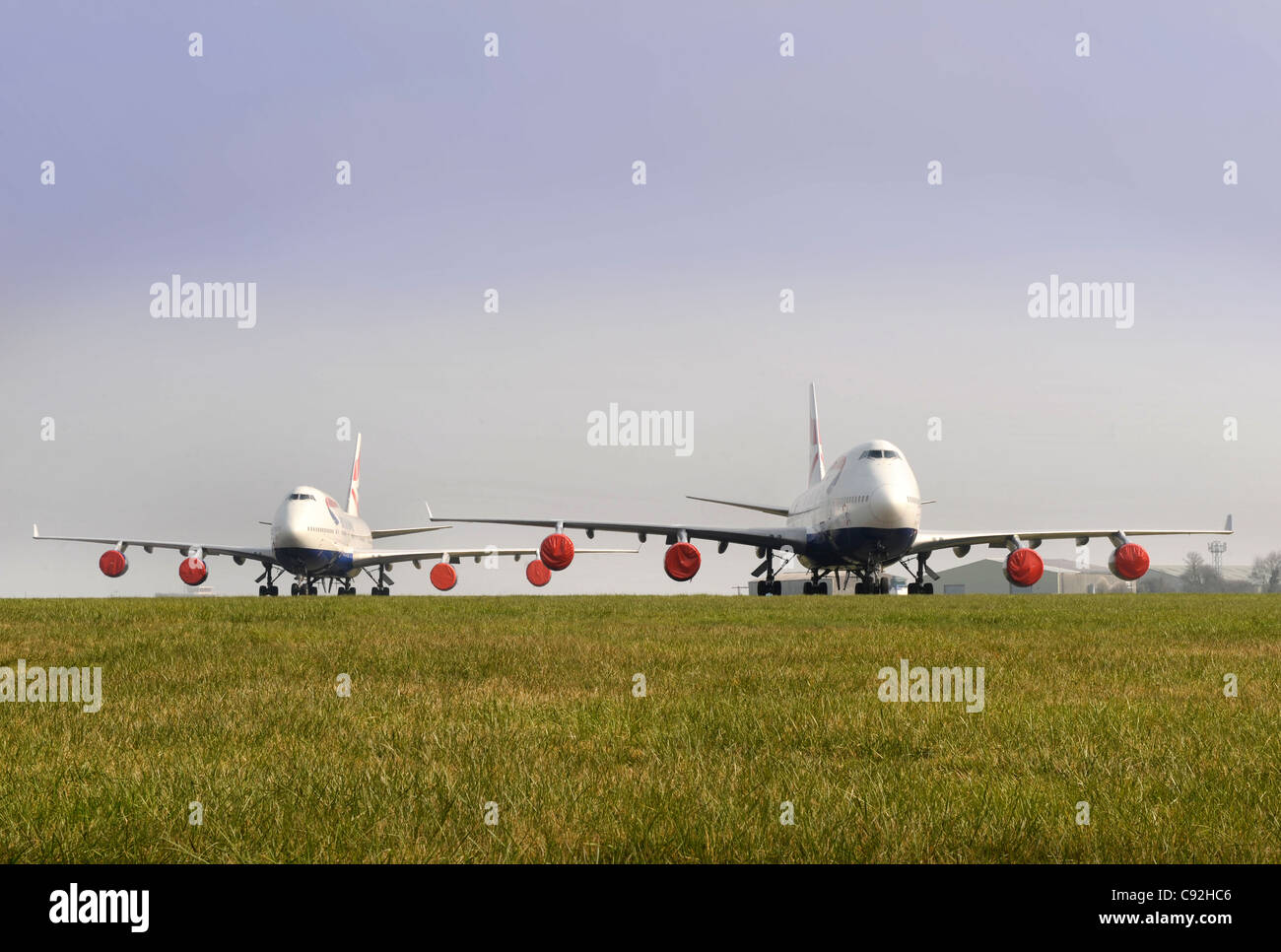 Two British Airways Boeing 747 passenger jets with engine covers parked ...