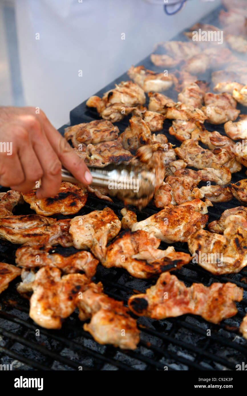 Cook at Basin restaurant prepearing grilled chicken, Petra, Jordan ...