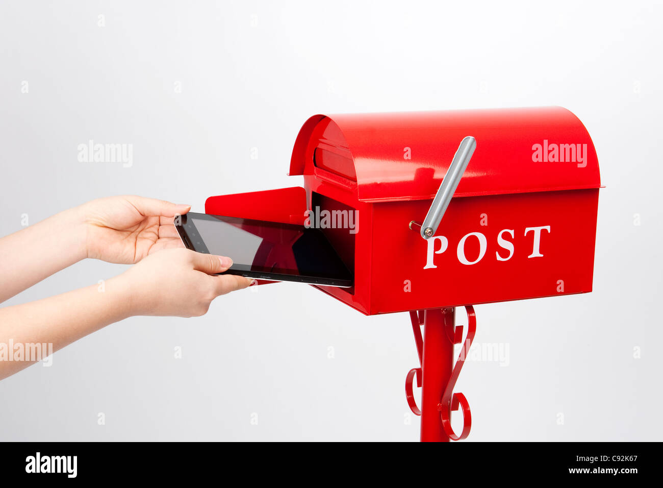 Human hand putting ipad into mailbox Stock Photo - Alamy