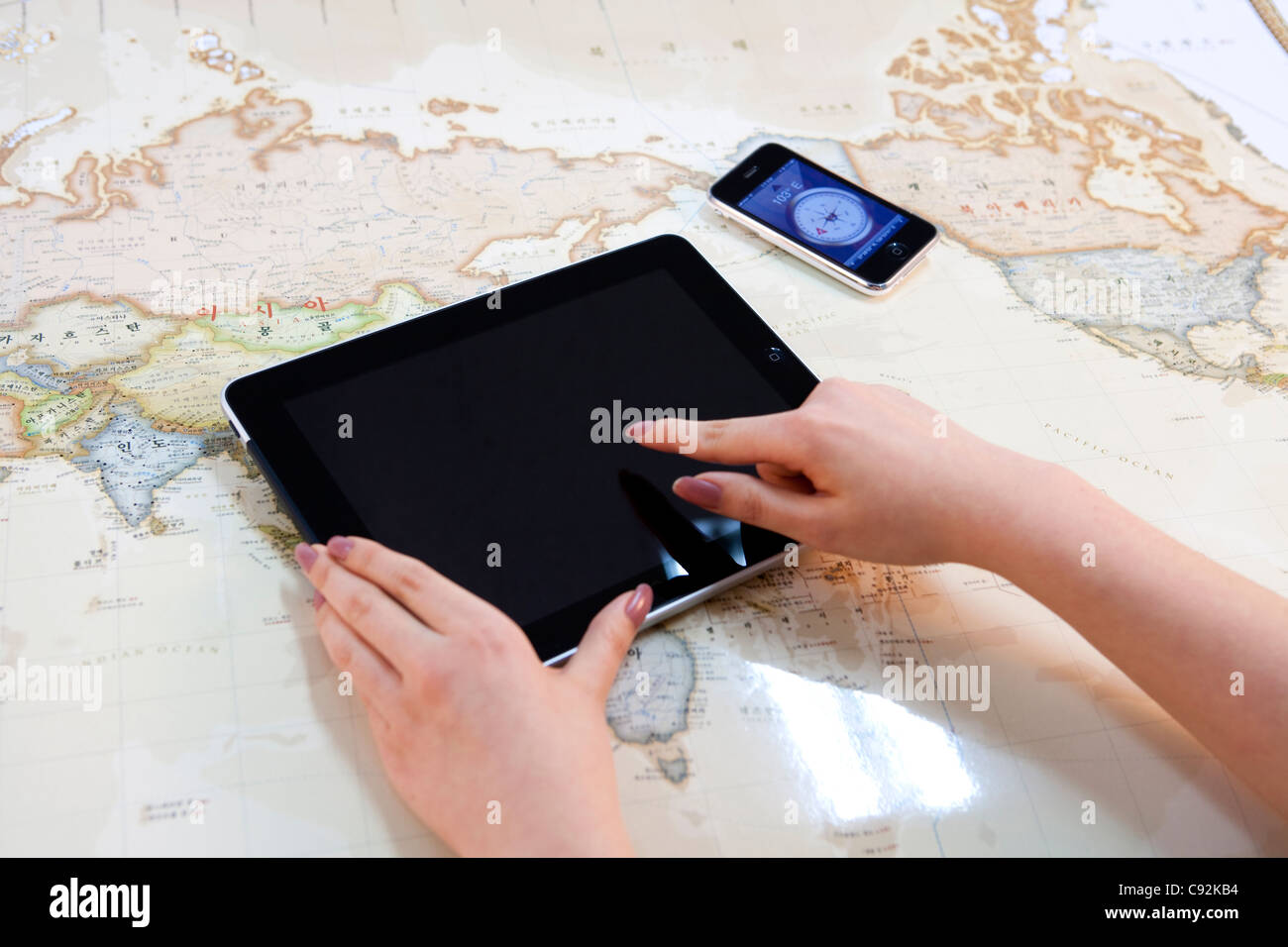 Human hand touching touch pad screen with mobile phone on map Stock ...