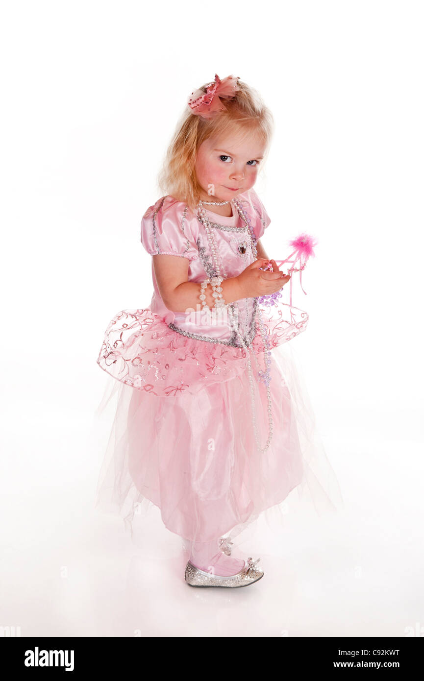little girl in pink fairy dress with mischievous expression against ...