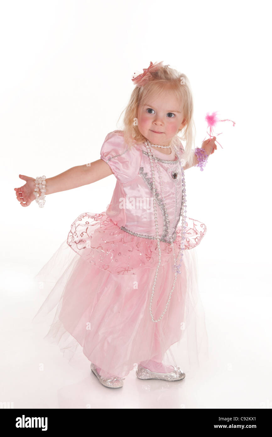 pretty little girl in pink princess dress dancing for camera against ...
