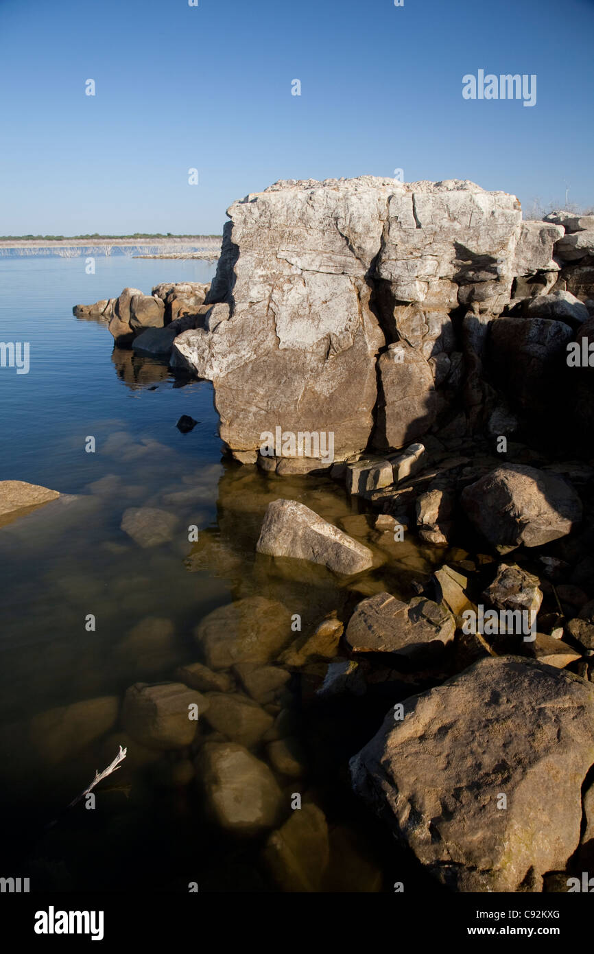 Low water levels caused by drought expose rocks and brush on the United ...