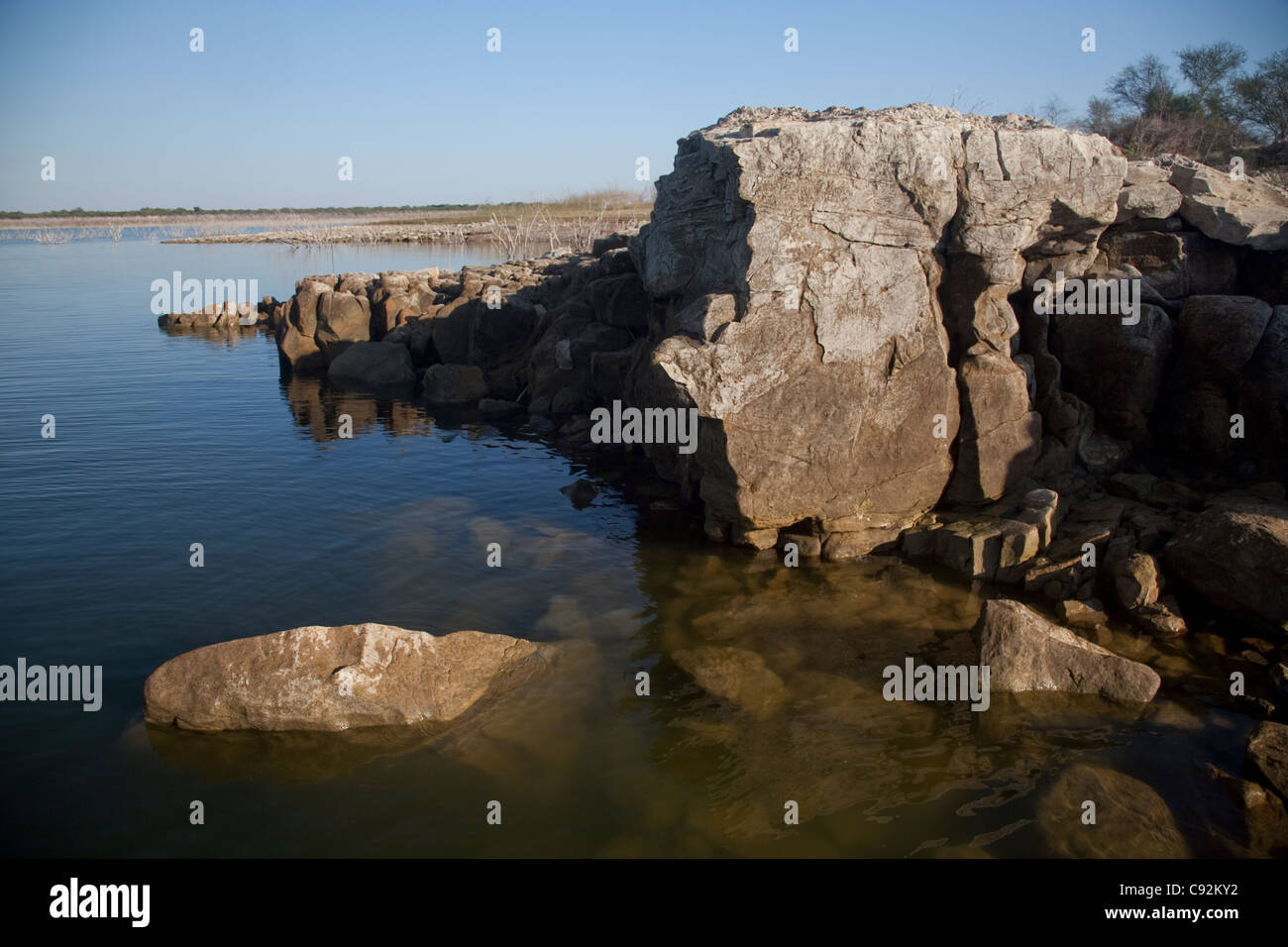 Low water levels caused by drought expose rocks and brush on the United ...