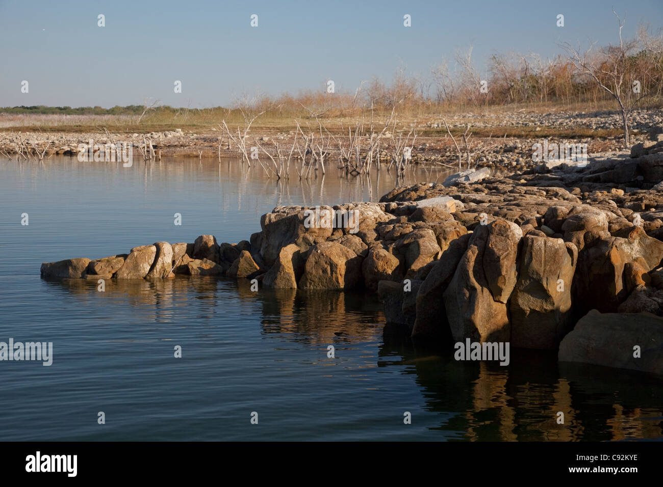 Low water levels caused by drought expose rocks and brush on the United ...