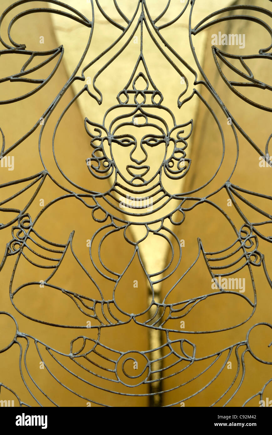 Doorway with gate of steel in pattern of holy entity, Pha That Luang ...