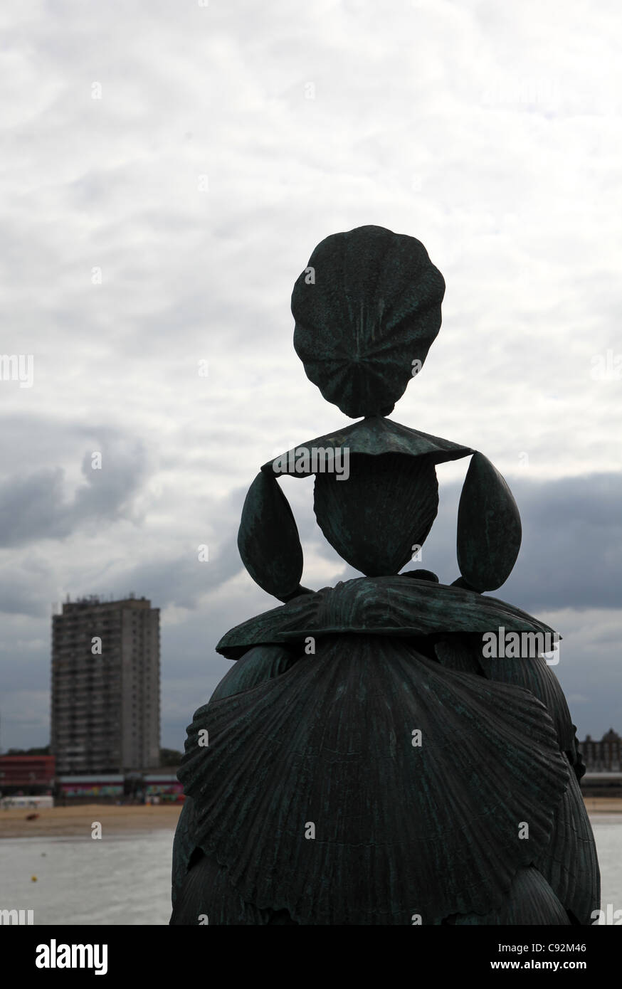 A giant sized statue of a lady made from shells overlooking Arlington ...