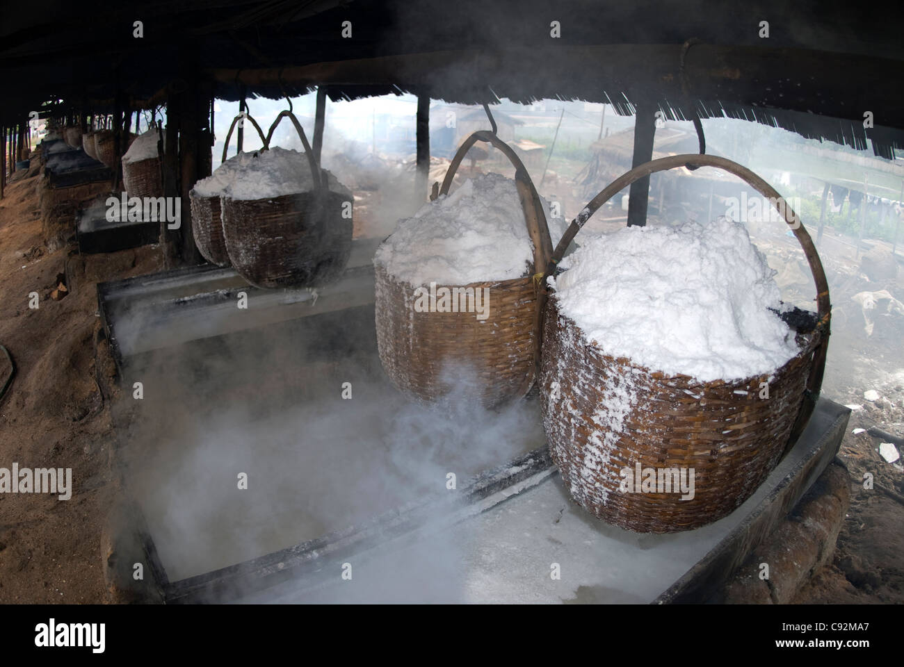 Salt in baskets over steaming water, Salt Factory, between Vientiane ...