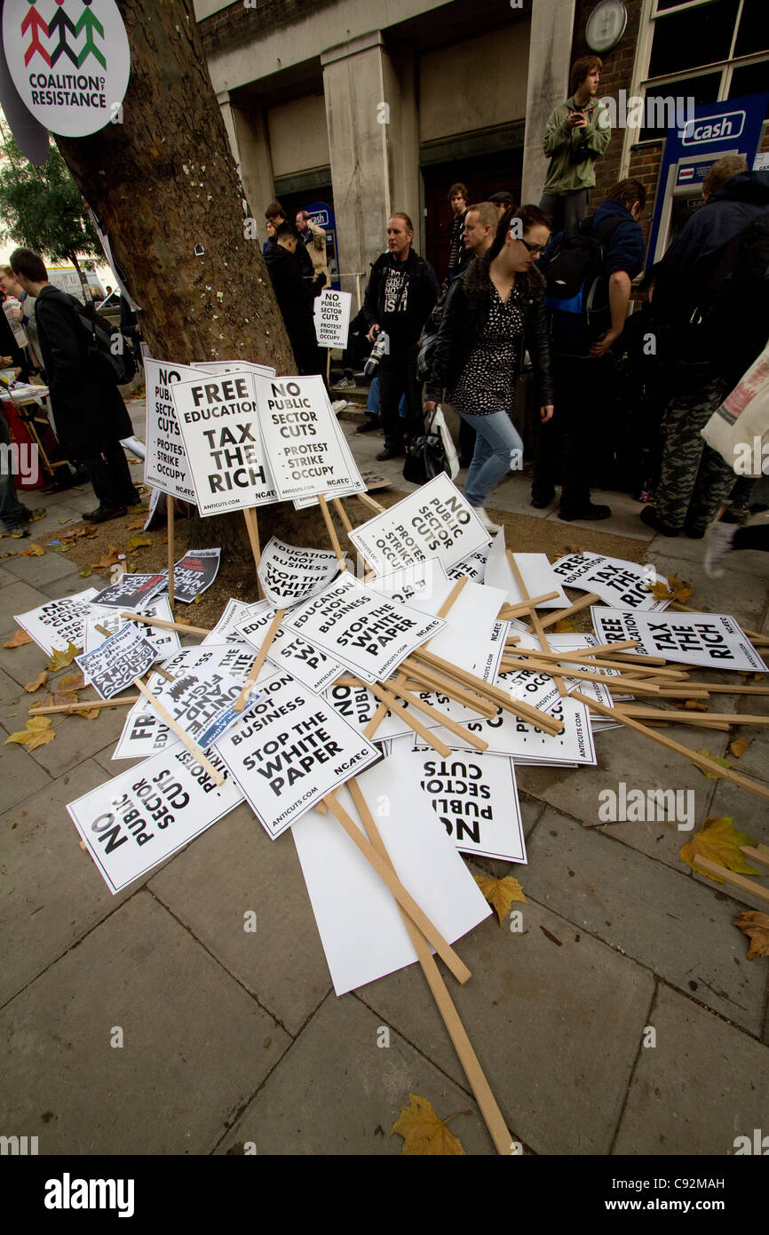A protester jumps over a pile of placards as students march through ...