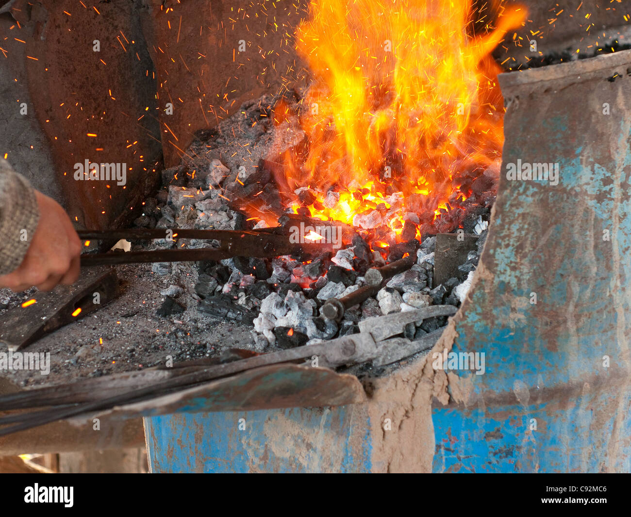 Blacksmith working on an object in the hot coal Stock Photo - Alamy