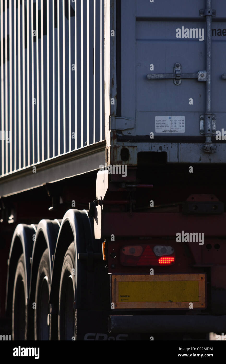 a low level view of part of a container truck as it travels along a ...