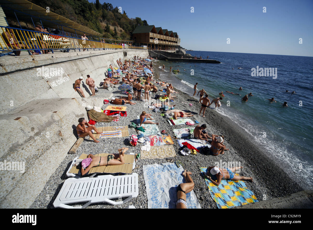 SUN BATHERS ON BEACH ALUPKA CRIMEA UKRAINE 28 September 2011 Stock ...