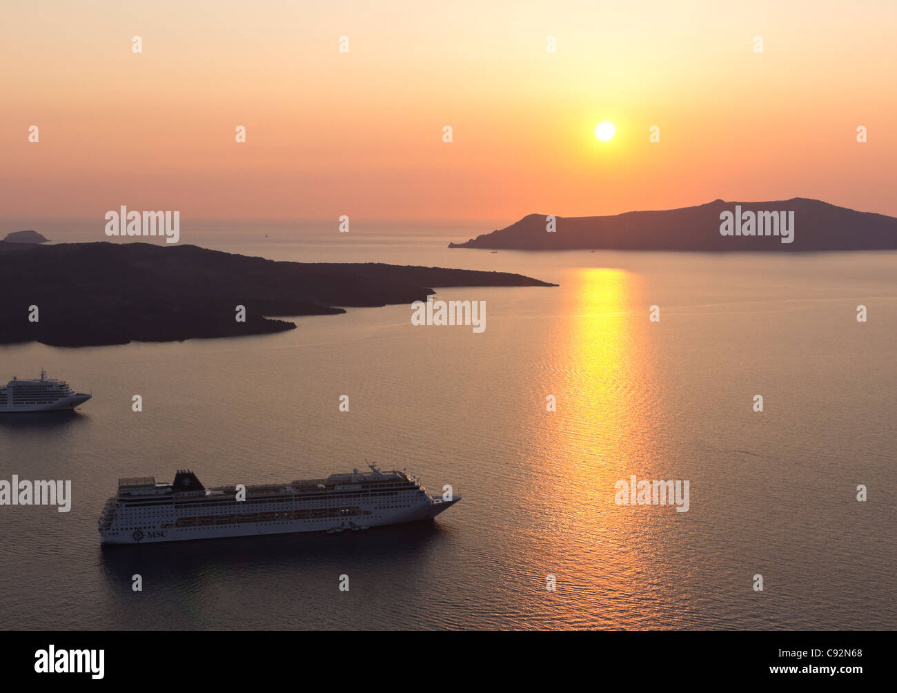 Santorini - sunset from Fira over the islands of the volcanic caldera ...