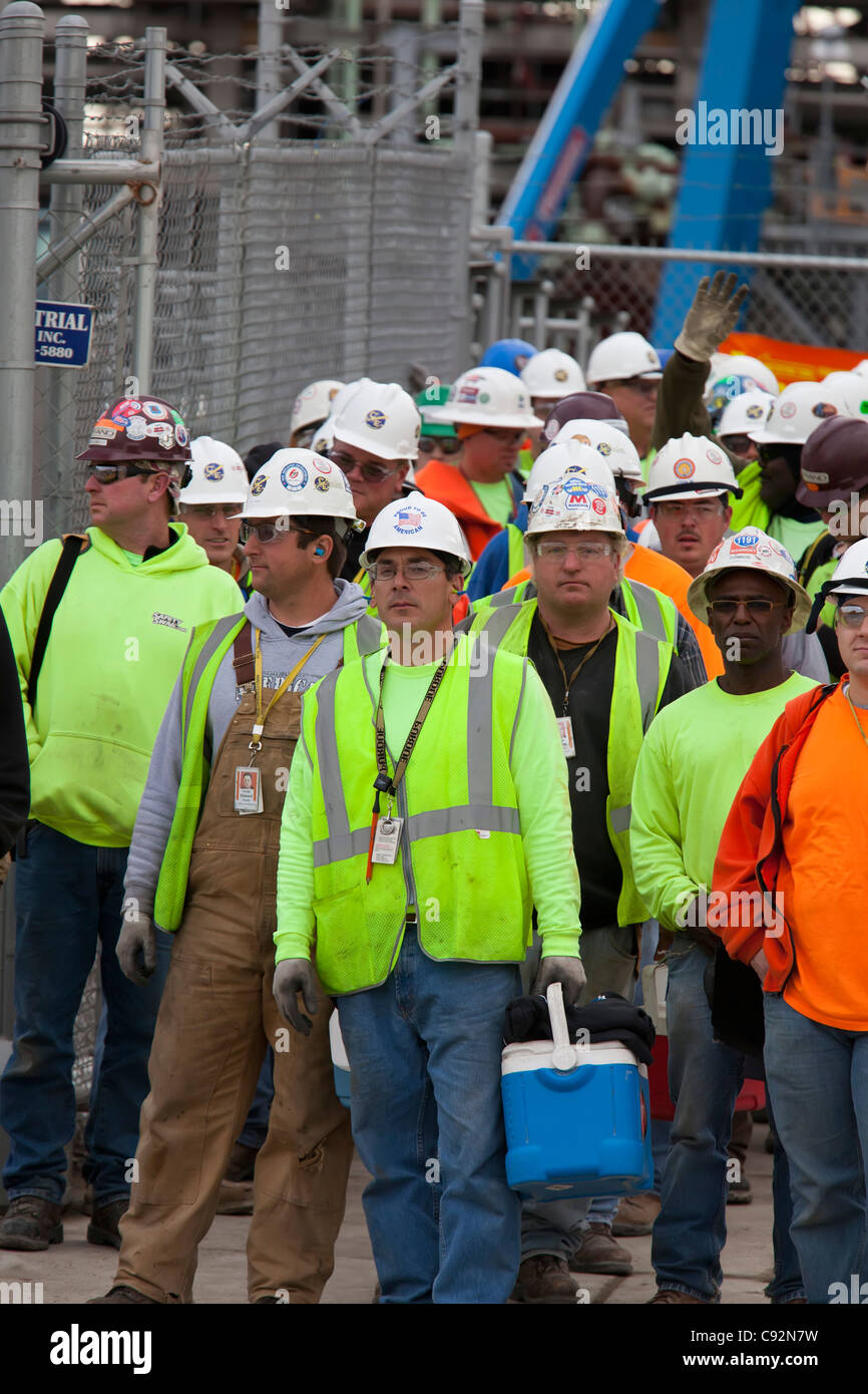 Construction Workers Shift Change at Oil Refinery. They are expanding ...