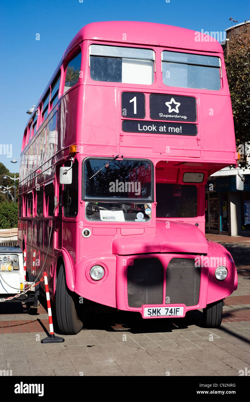 bright pink double decker bus used in promotion for pharmacy chain ...