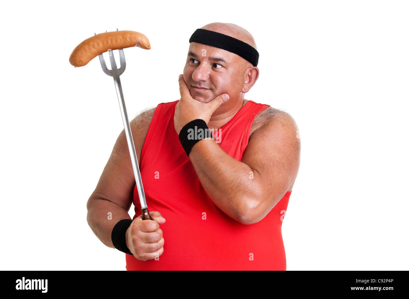 Large fitness man looking at a big sausage isolated in white Stock ...
