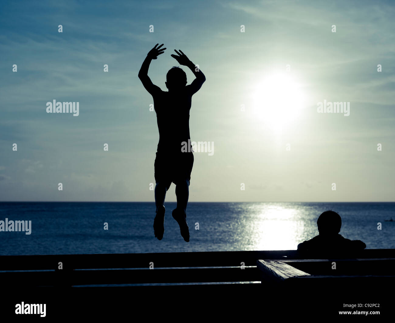 Boy jumping into the sea hi-res stock photography and images - Alamy
