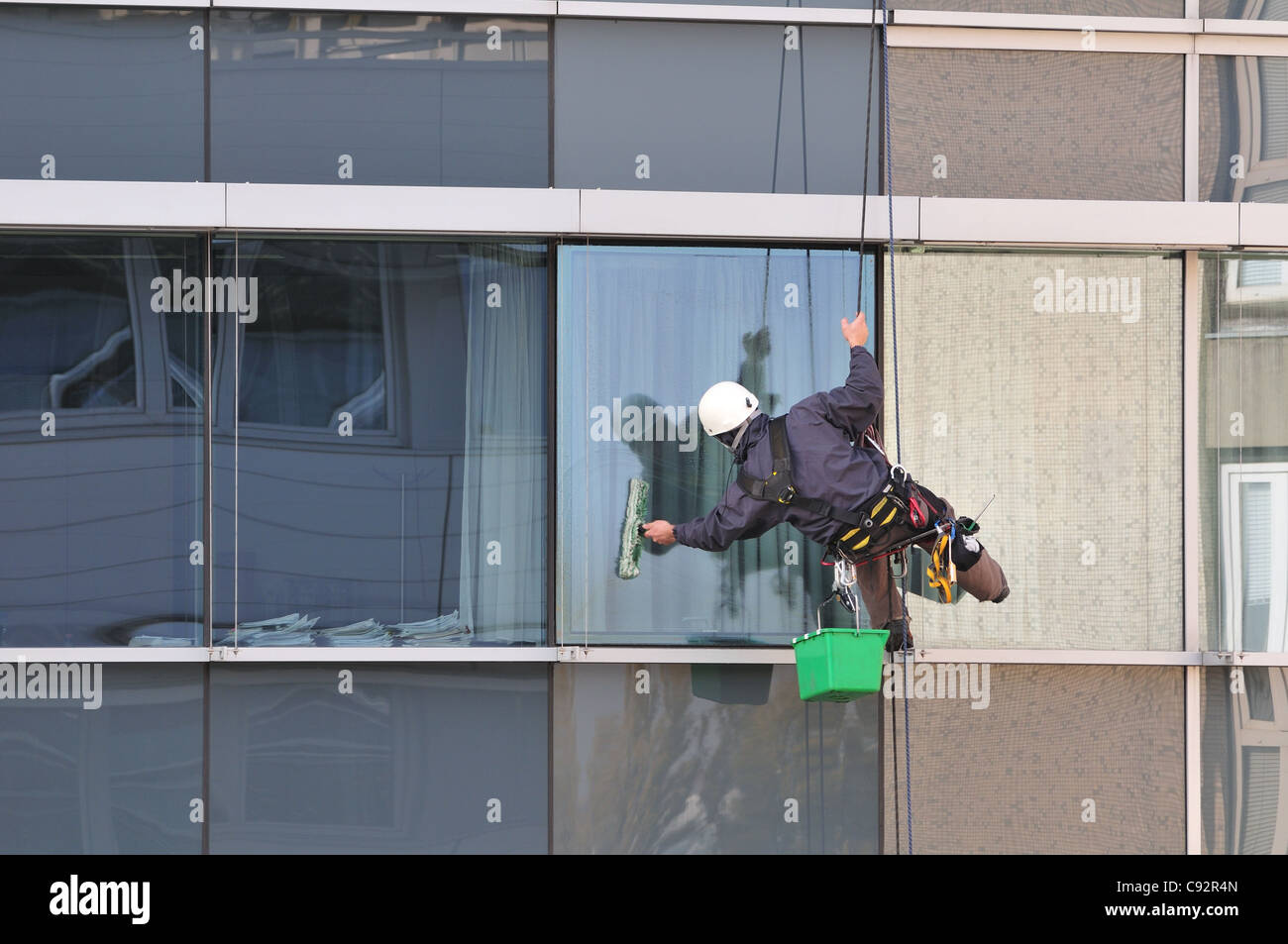 Window cleaner, working on the outside of an office building Stock ...