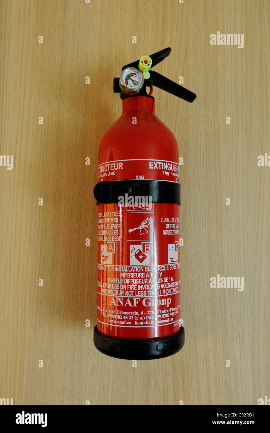 Red powder fire extinguisher attached to interior wall of caravan ...