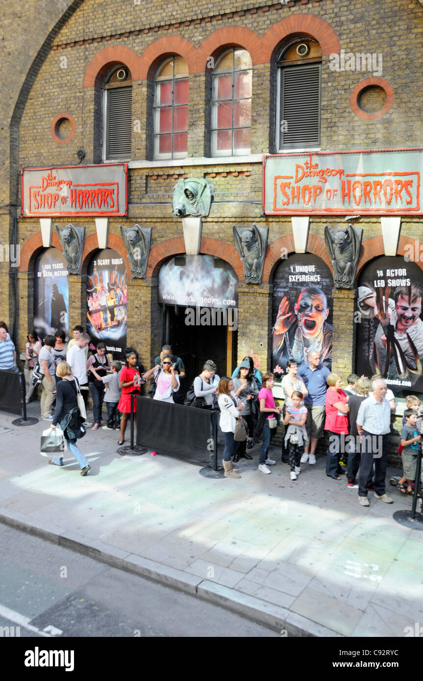 Looking down on group of people waiting in line queuing to buy tickets ...
