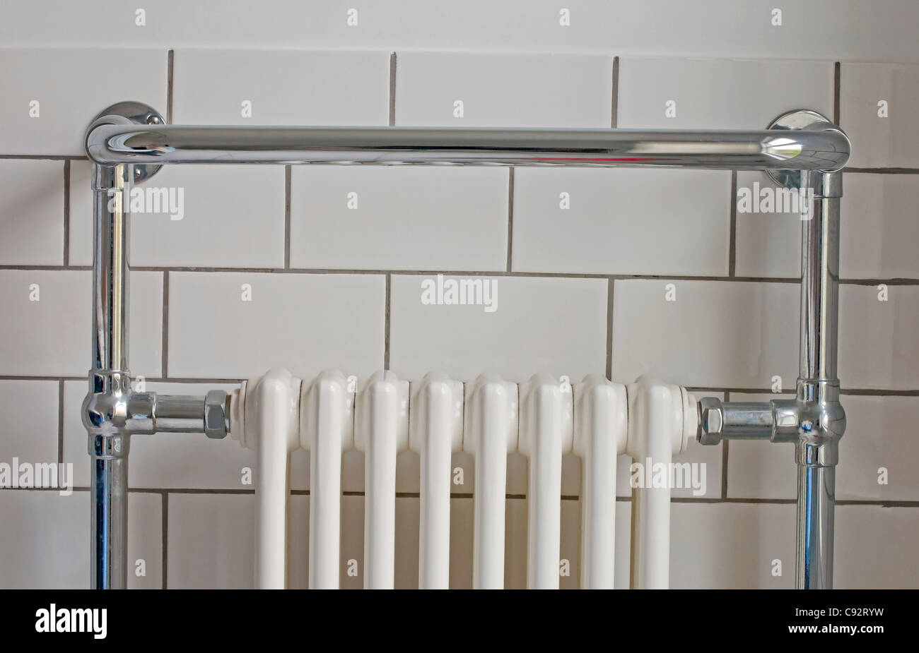 A chrome antique Victorian style radiator in a tiled bathroom Stock ...