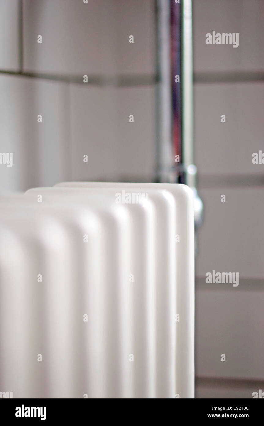 A chrome antique Victorian style radiator in a tiled bathroom Stock ...