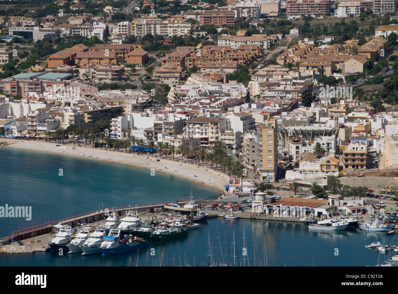 Scenic view of beach, harbour with boats and town, Javea, Between ...
