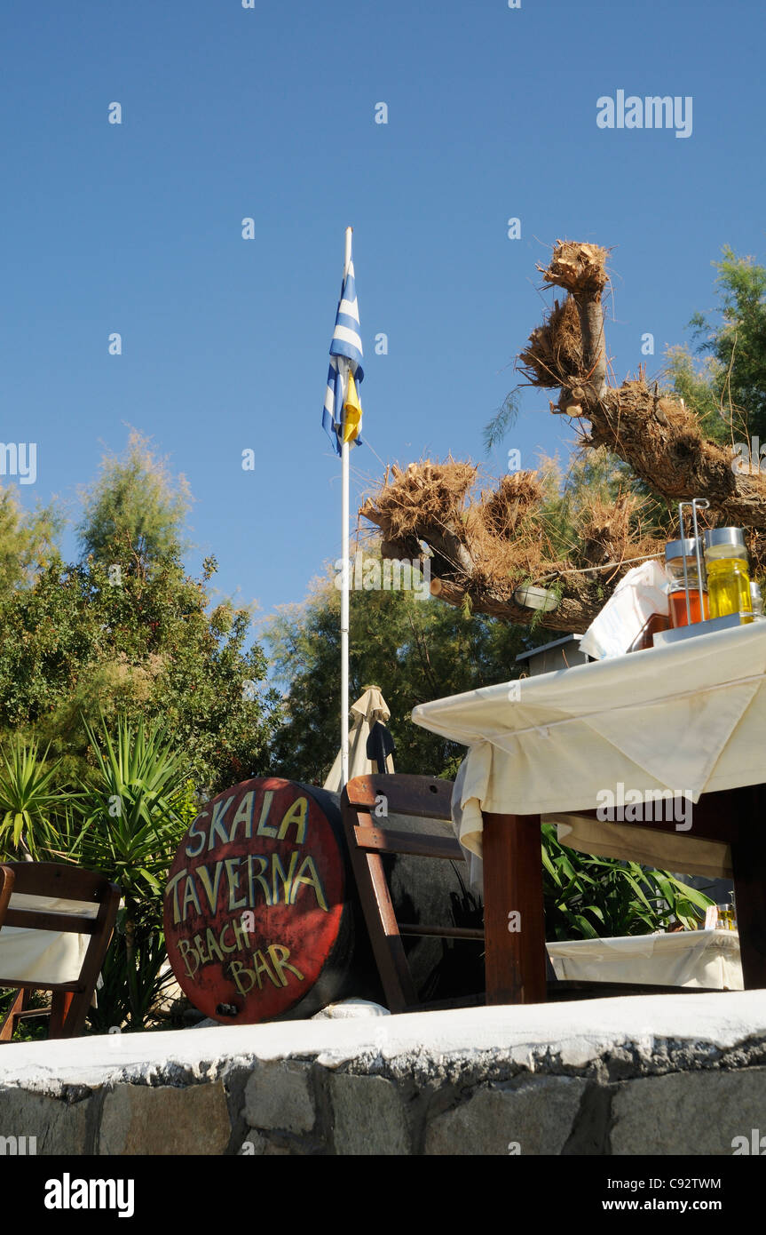 An open air restaurant table set on a terrace amongst trees Stock Photo ...