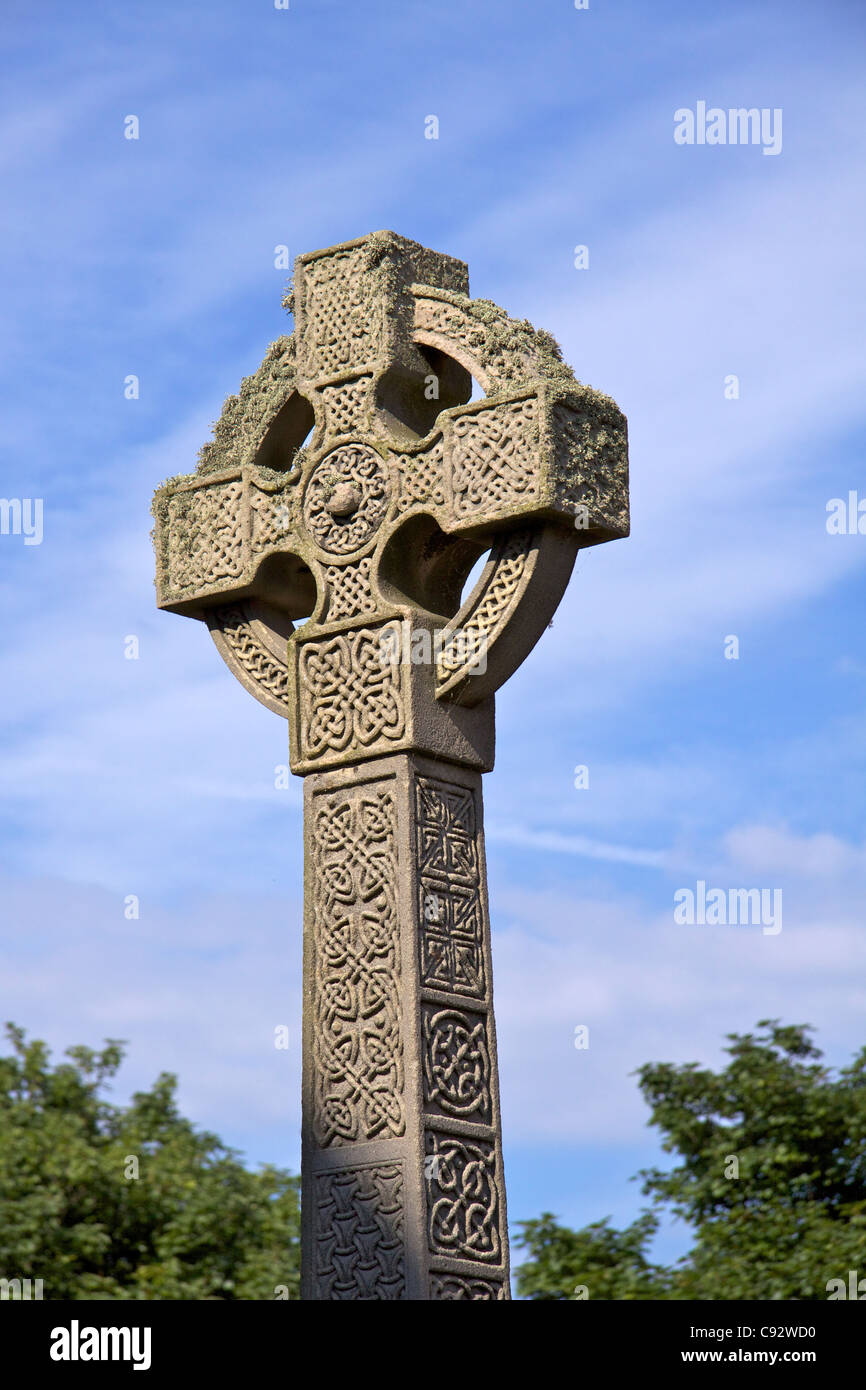 Carved Celtic stone cross in the monastery grounds at Lindsifarne on ...