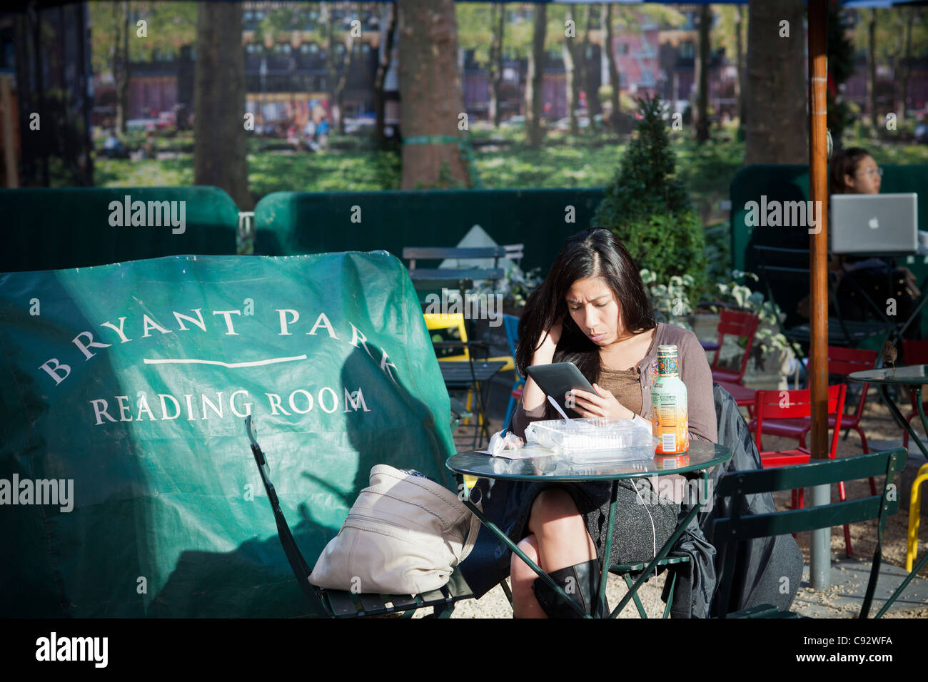 A woman reads on her Amazon Kindle in Bryant Park in New York on ...
