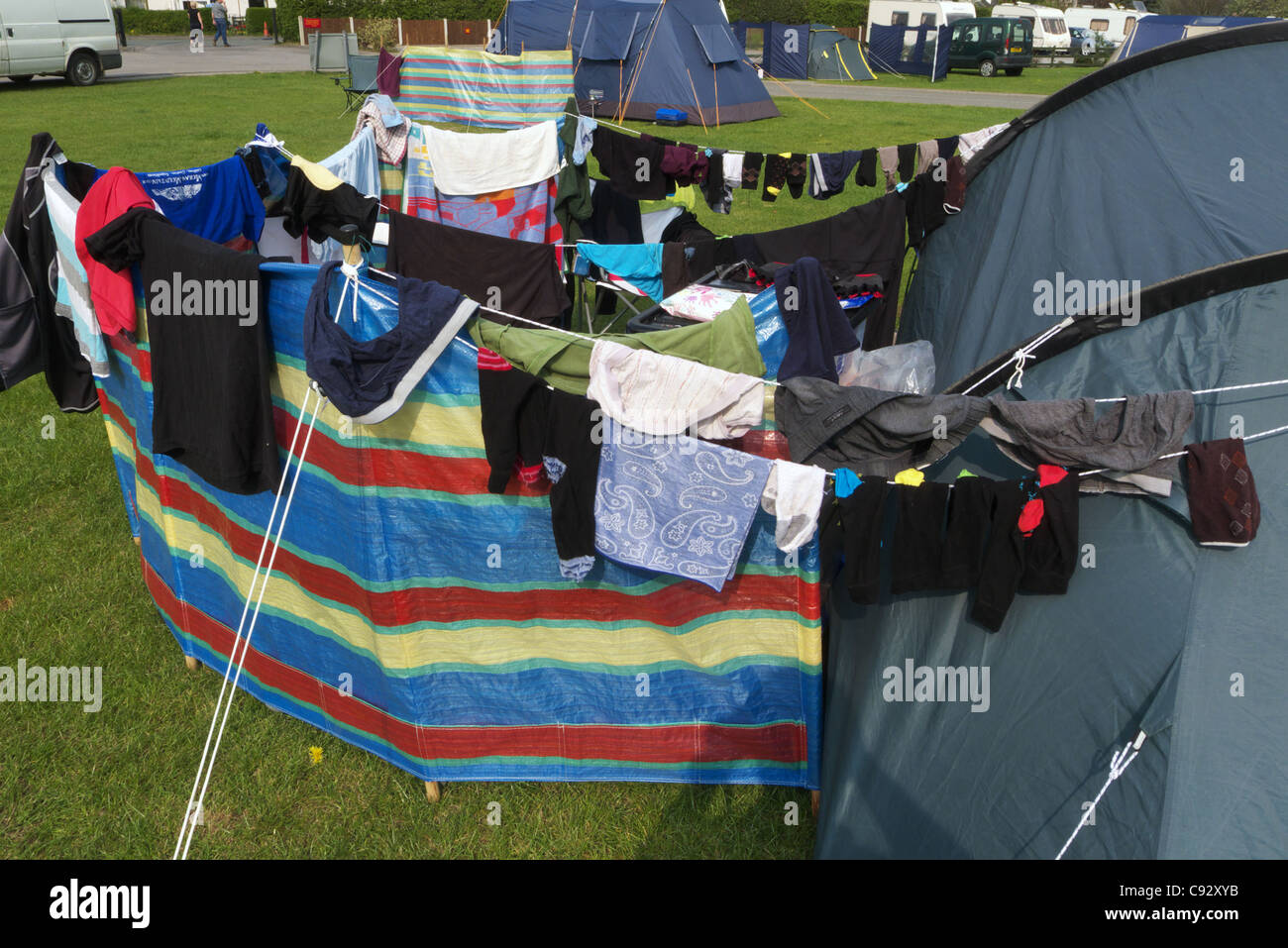 Washing drying around a tent on a campsite Stock Photo - Alamy