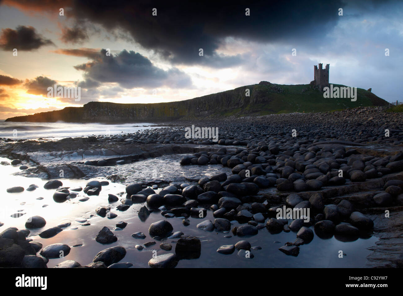 Dunstanburgh Castle is a historic ruin on a headland, founded in the ...
