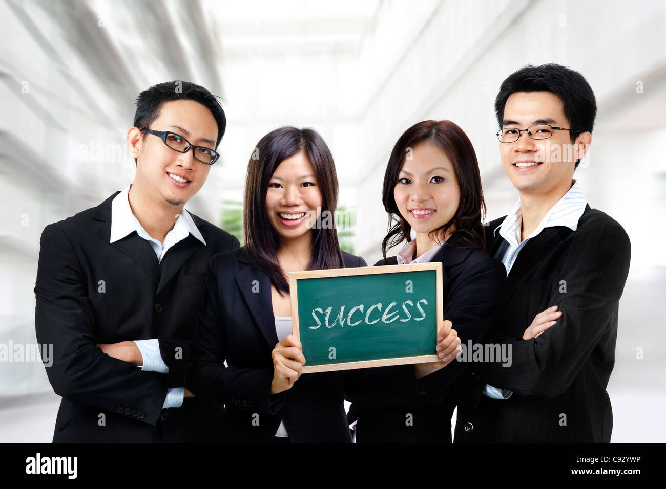 Asian business team on office background, blackboard on hand Stock ...