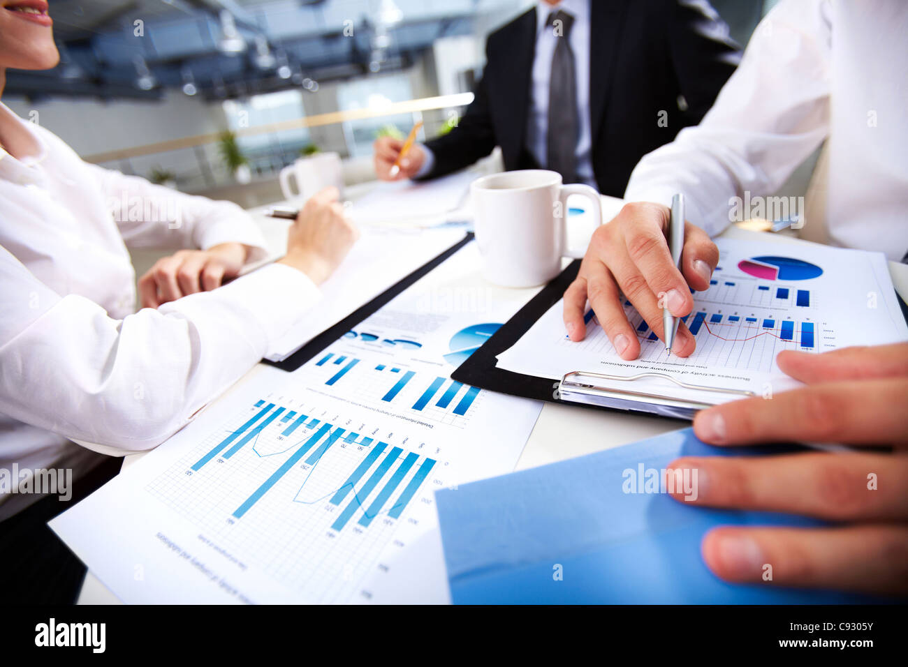Hands of business people over documents Stock Photo - Alamy