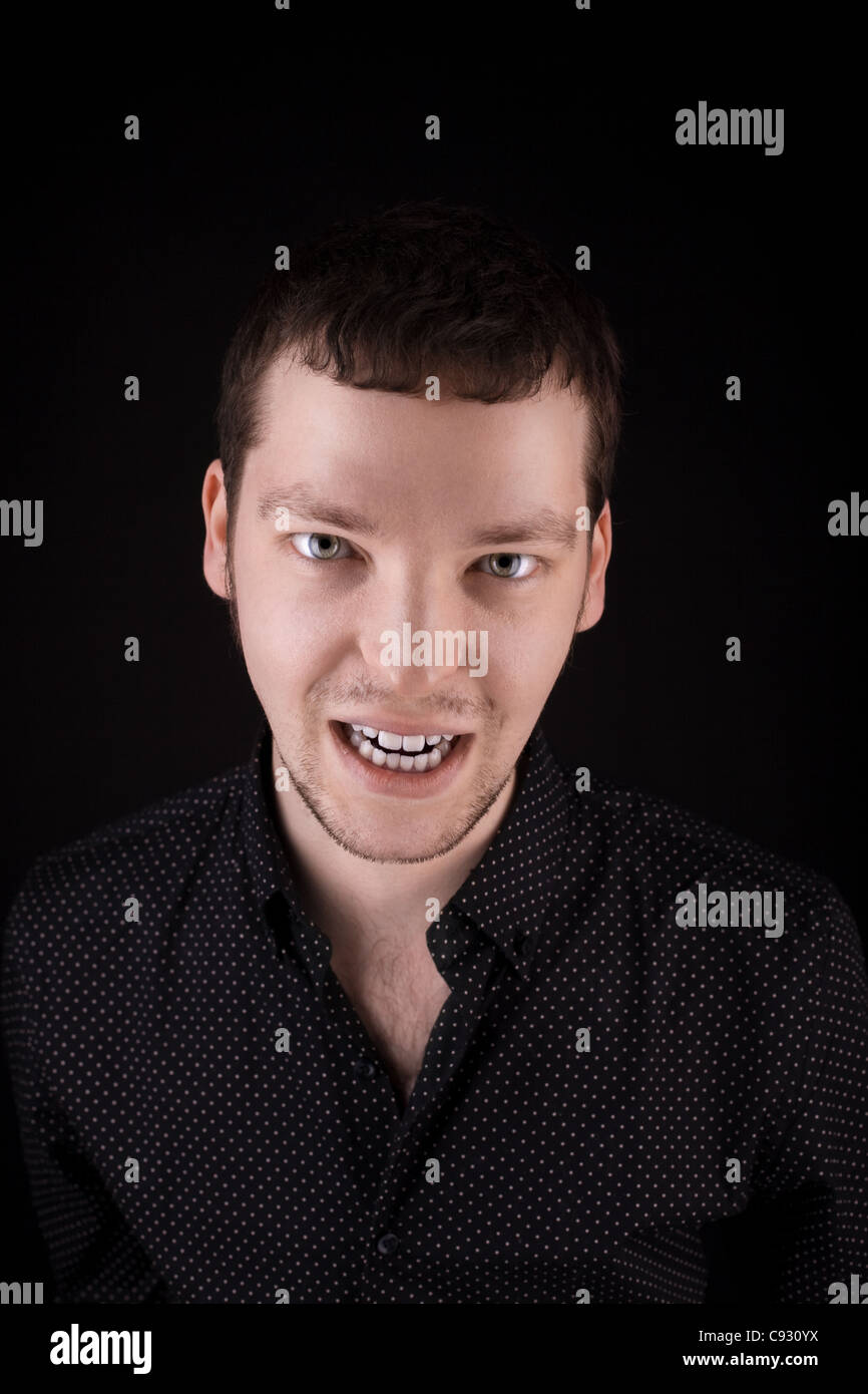 Portrait of anger man look at you from dark Stock Photo - Alamy