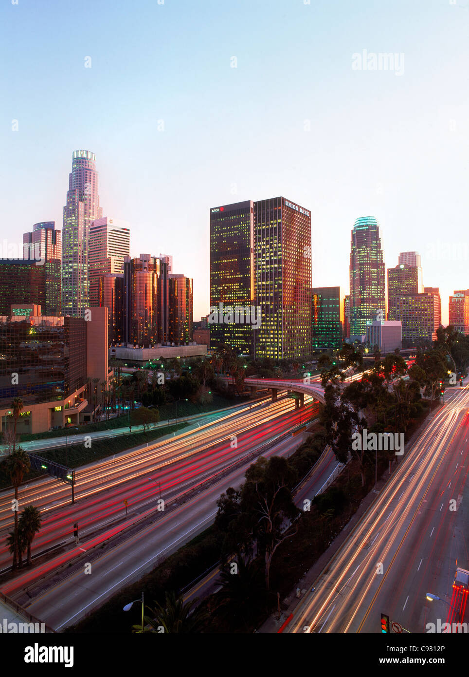 Downtown Los Angeles with rush hour traffic passing on roads and ...