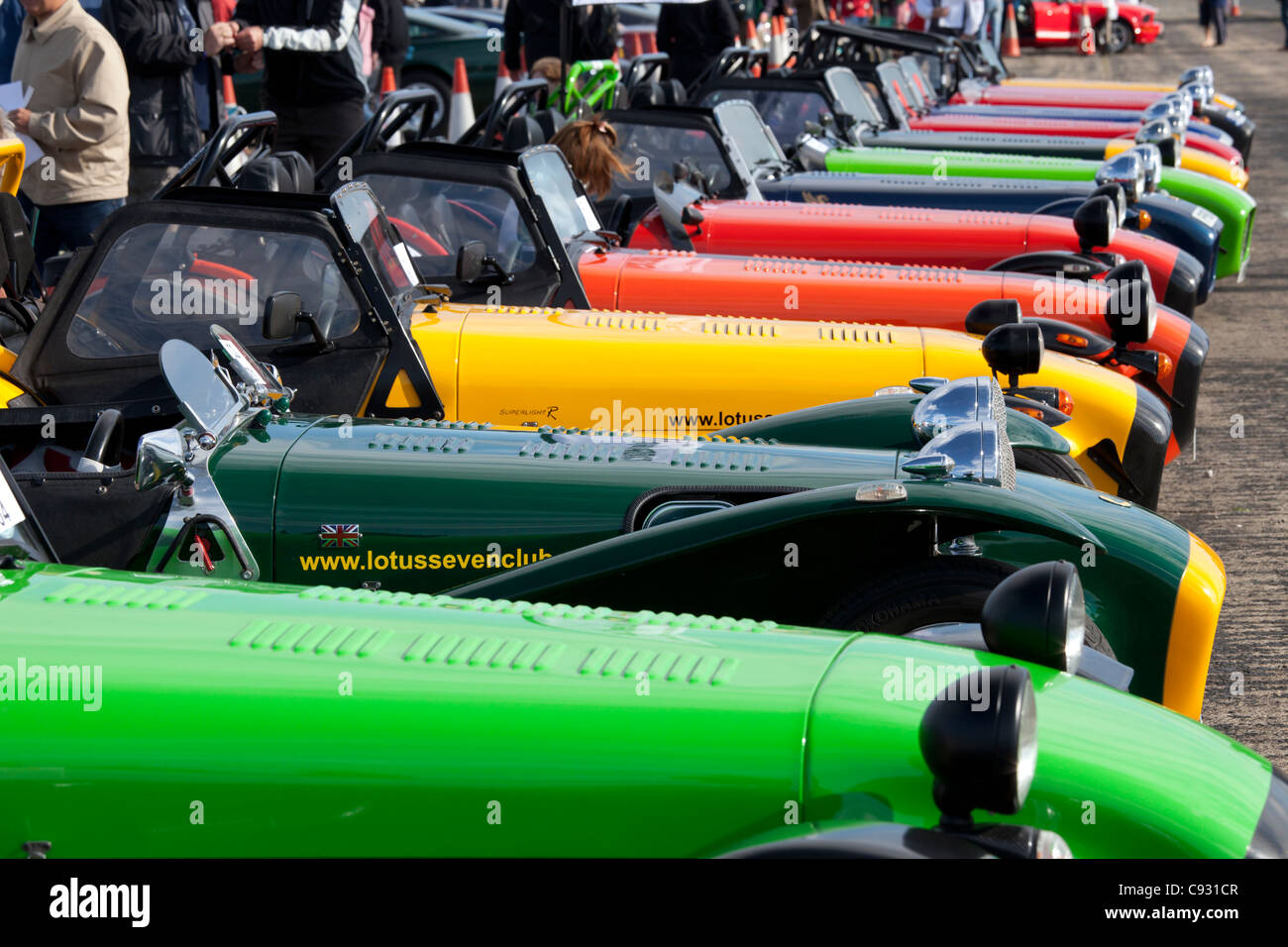 A row of colourful lotus sevens on display at Dunsfold Wings and Wheels ...