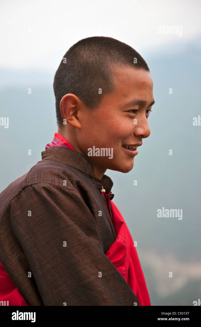 A young red-robed monk near Mongar Stock Photo - Alamy