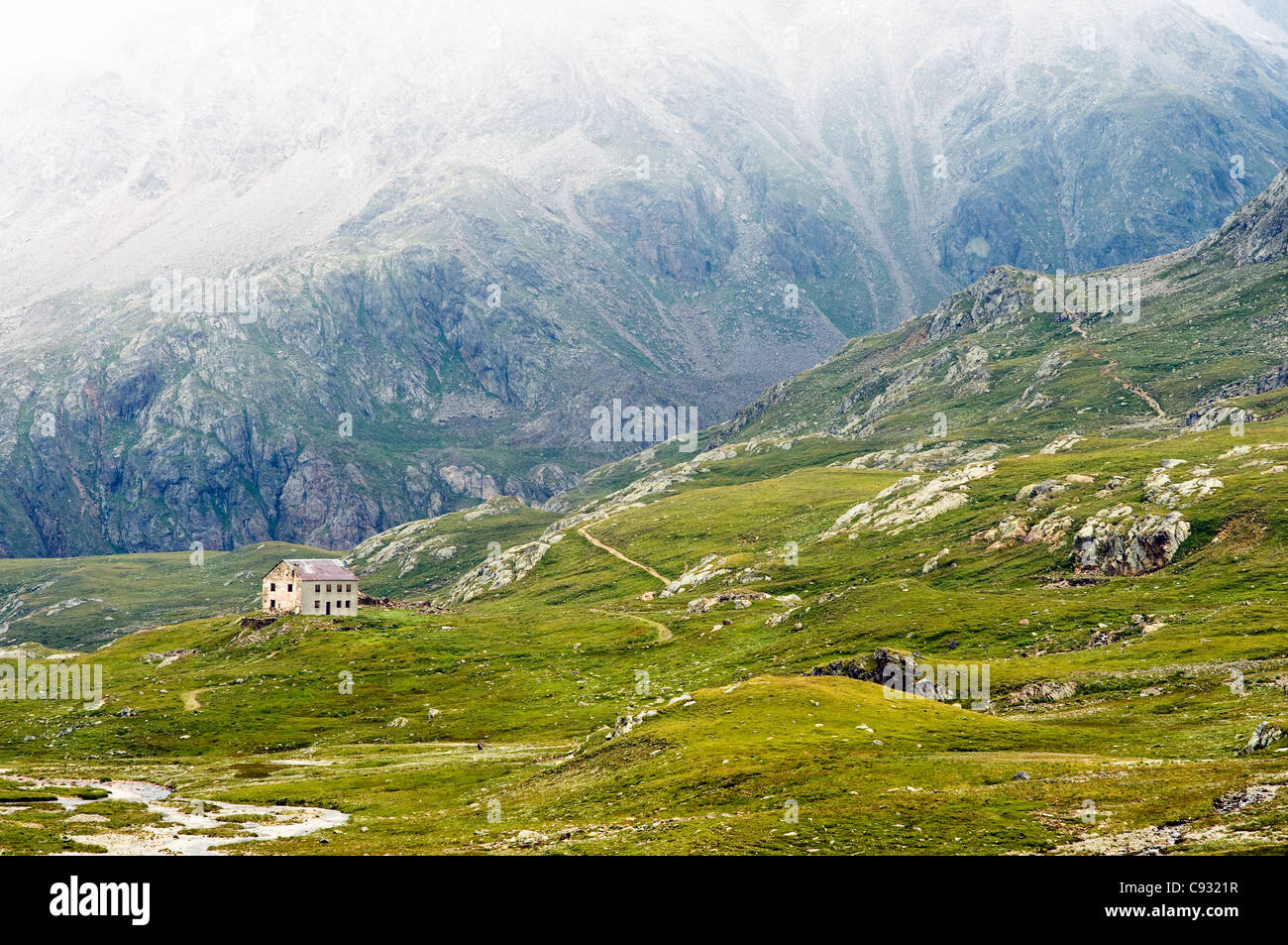 Small desolate house on the hillside in the Italian alps Stock Photo ...