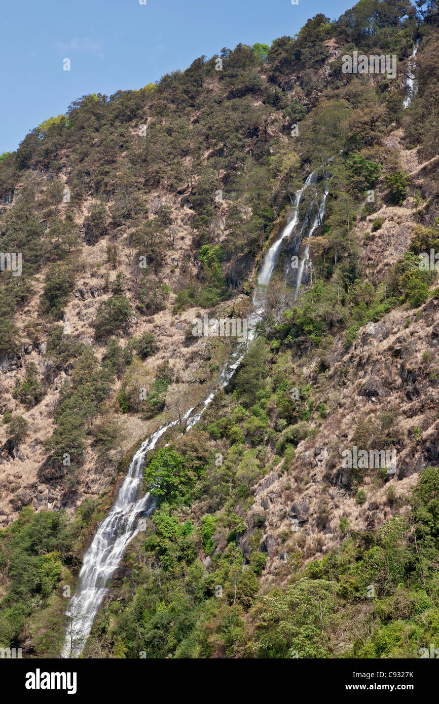 The impressive Kuenga Rabten waterfall cascades down the steep mountain ...