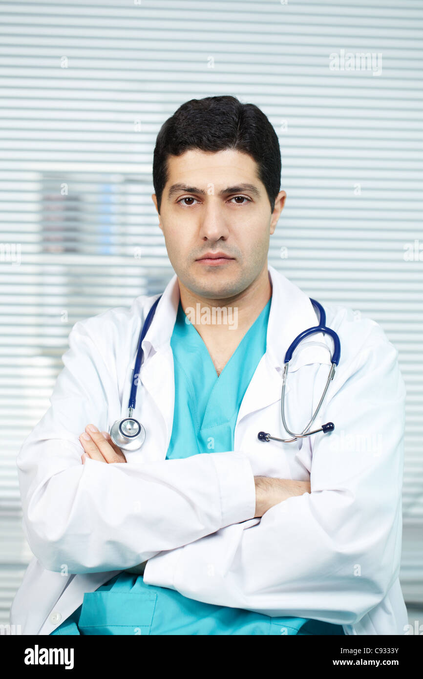 Portrait of serious doctor with stethoscope looking at camera Stock ...