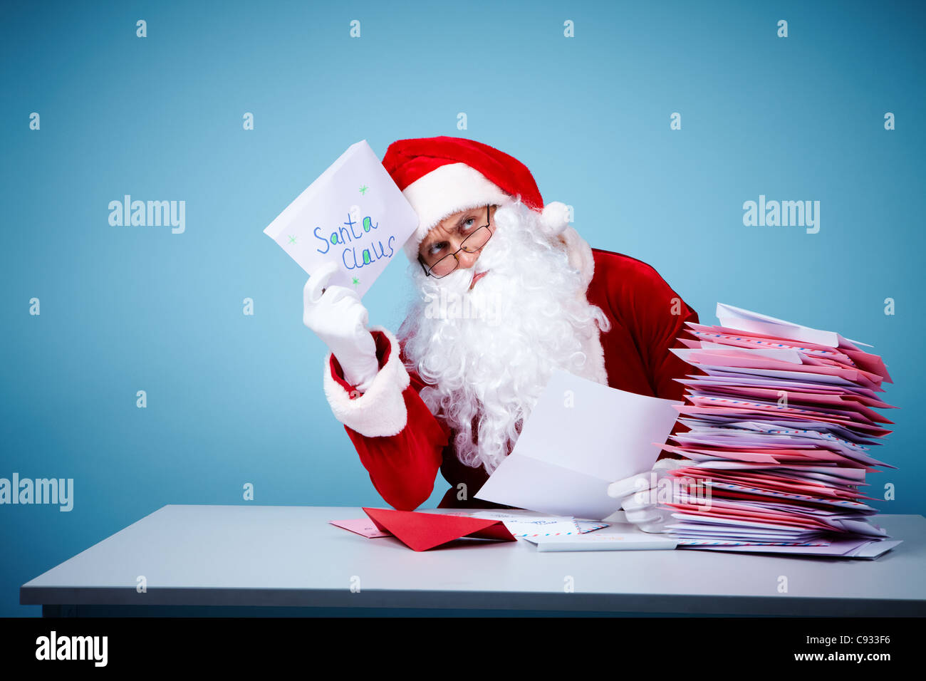 Portrait of Santa Claus thinking about ideas while reading letters ...