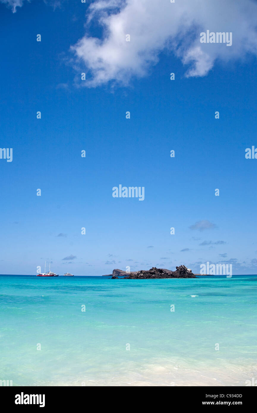 Ecuador, Galapagos. Tourist yachts moored off the stunning beaches of ...