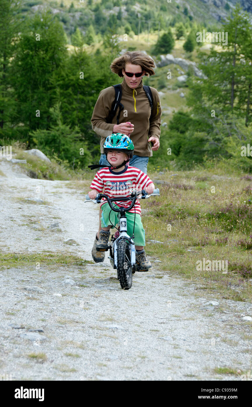 A boy learning to ride a bike Stock Photo - Alamy