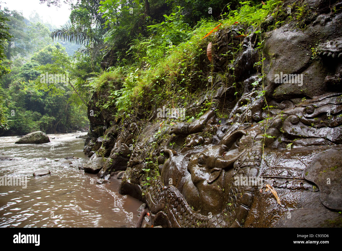 Bali, Ubud. Beautiful stone-carving adorns the rocky sides of a river ...