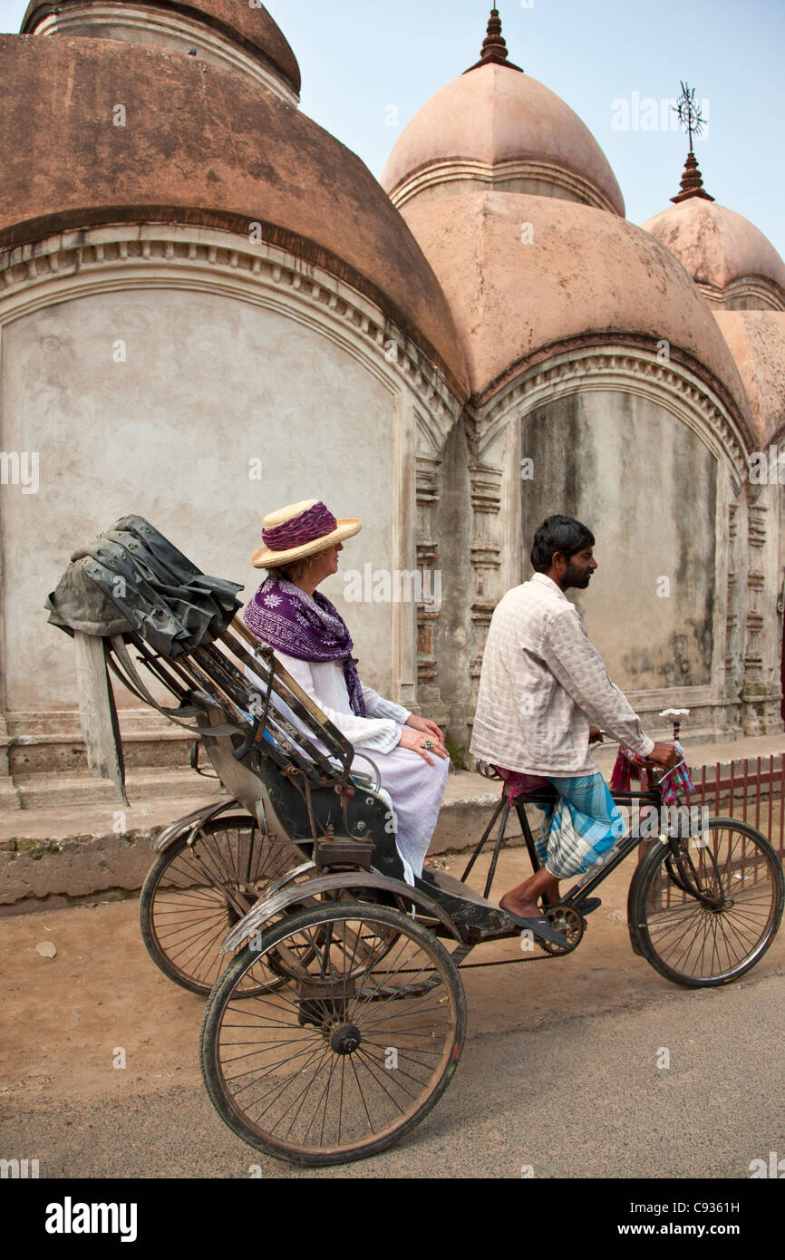 A tourist in a bicycle rickshaw outside the 108 Shiva brick Temples at ...
