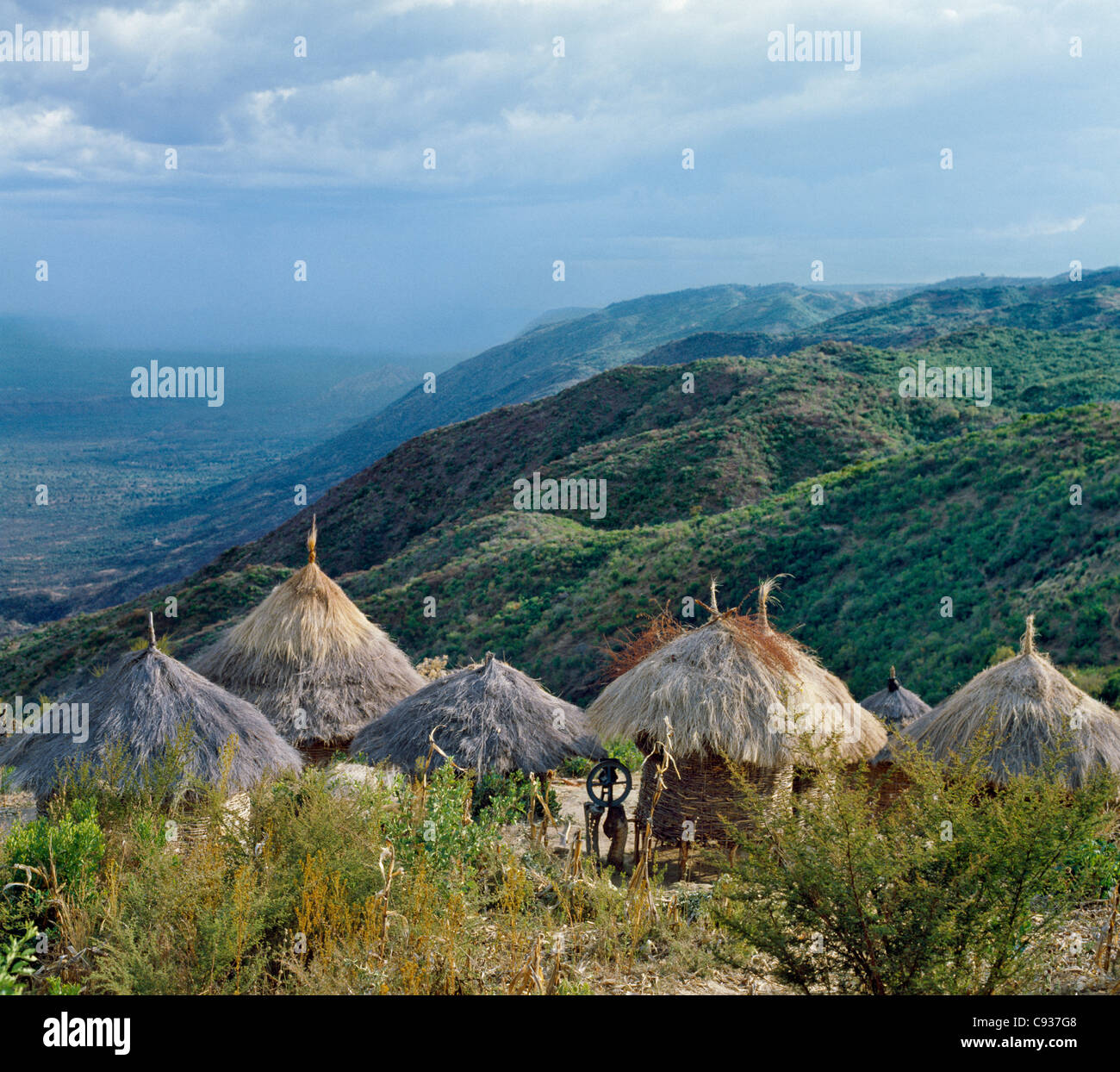A cluster of traditional houses with a maize grinder on the edge of the ...