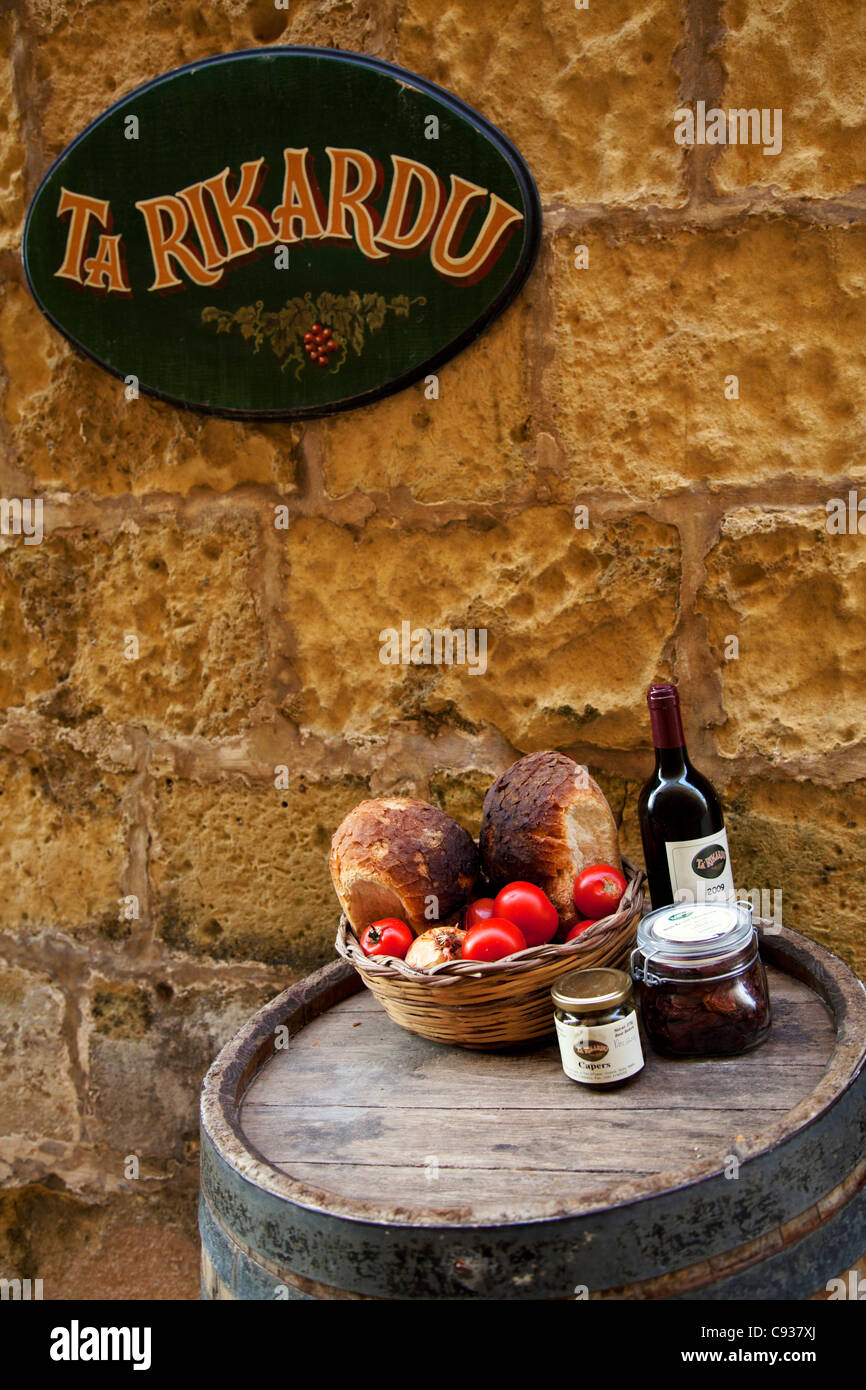 Gozo, Malta, Europe; The sign of a local tavern on the old walls of ...
