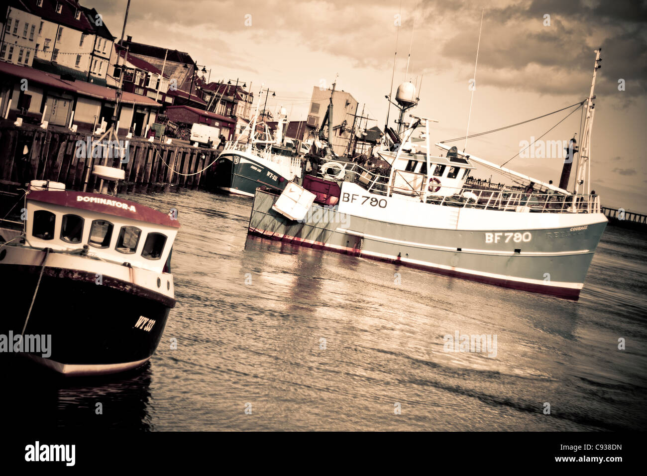 Whitby by the sea, with the boats at the docks and dockyard showing the ...